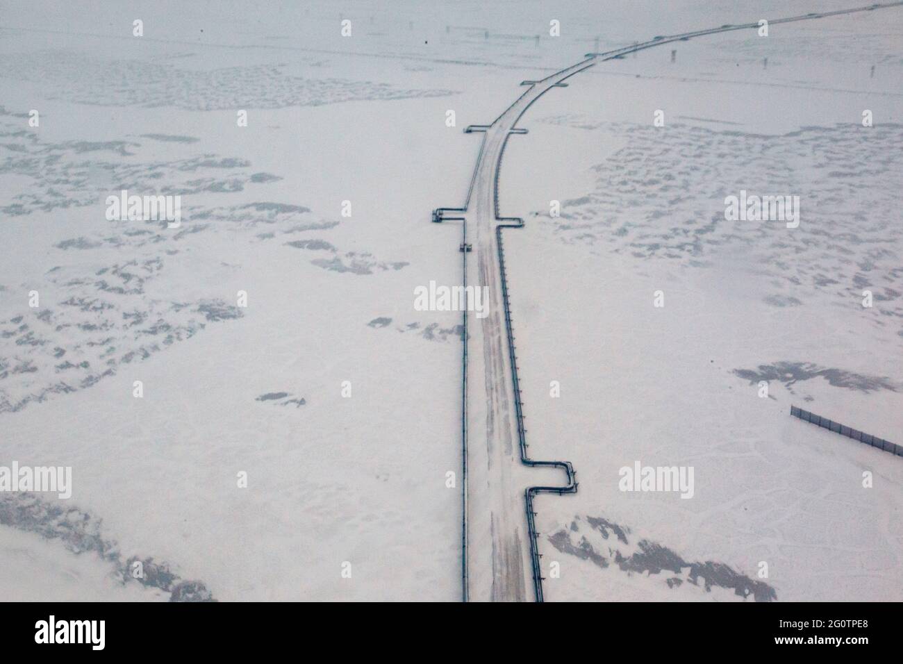 Oil pipeline and iceroad leading from the ConocoPhillips oilwells in ...