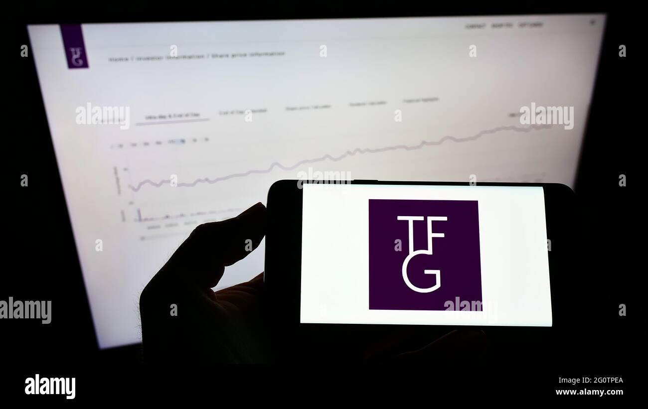 Person holding smartphone with logo of South African fashion company ...