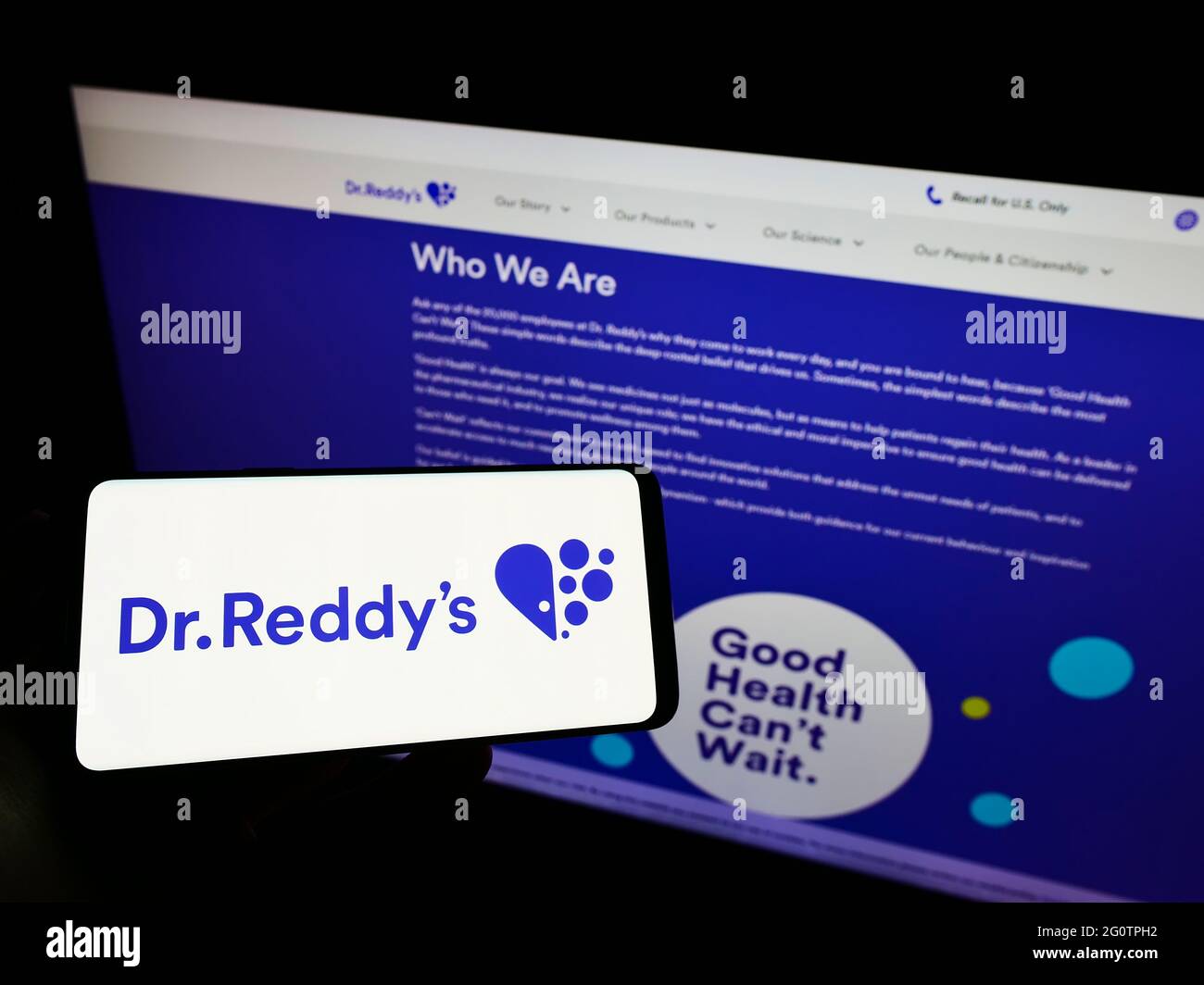 Person holding mobile phone with logo of pharmaceutical company Dr ...