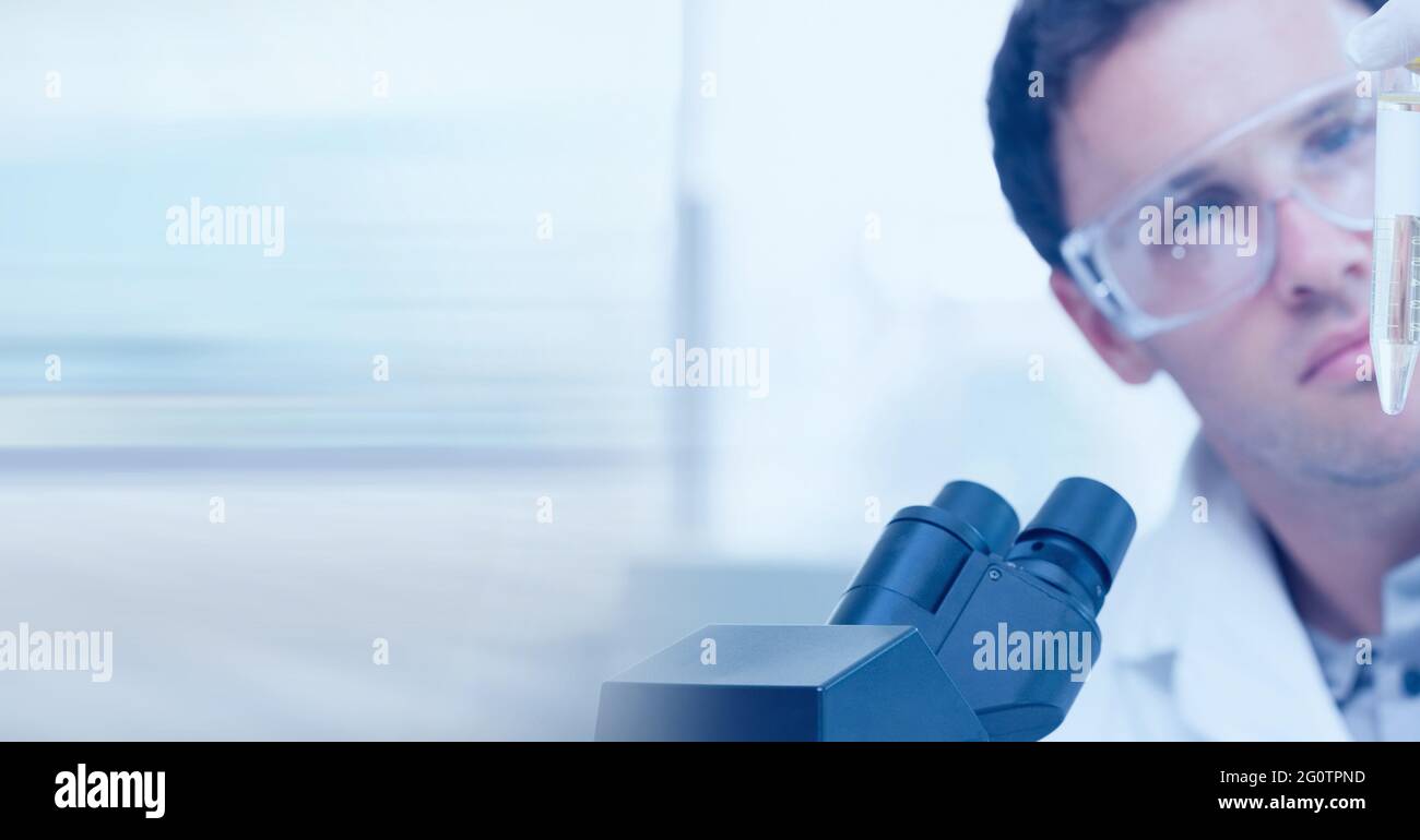 Composition of male scientist using microscope in laboratory with copy ...