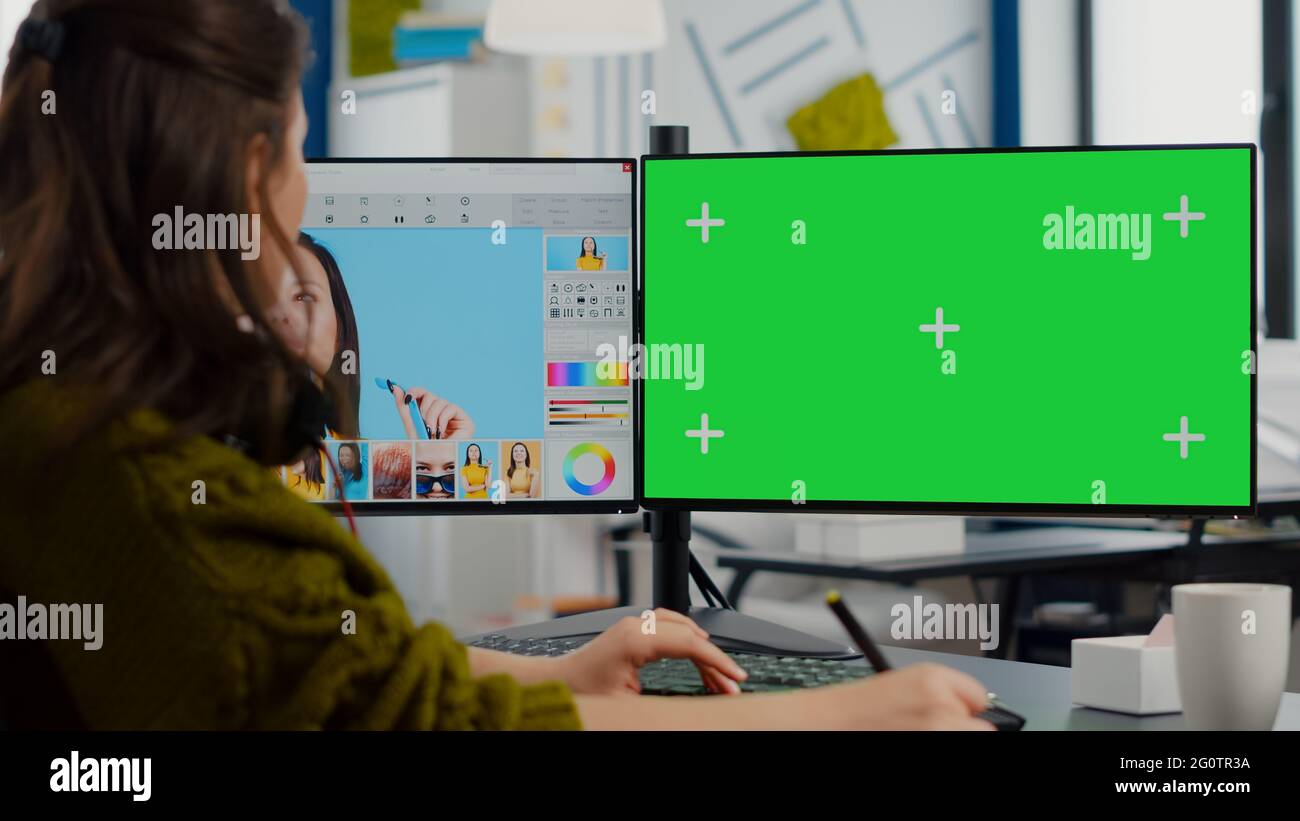 Creative woman retoucher editing assets in digital retouching program ...