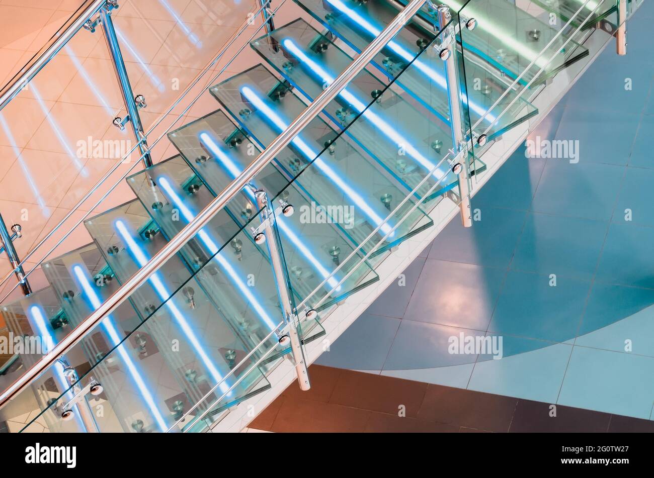 Metal glass staircase with neon, led backlight Stock Photo - Alamy