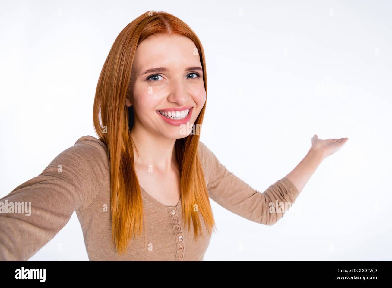Photo of sweet shiny ginger lady wear beige shirt smiling tacking ...