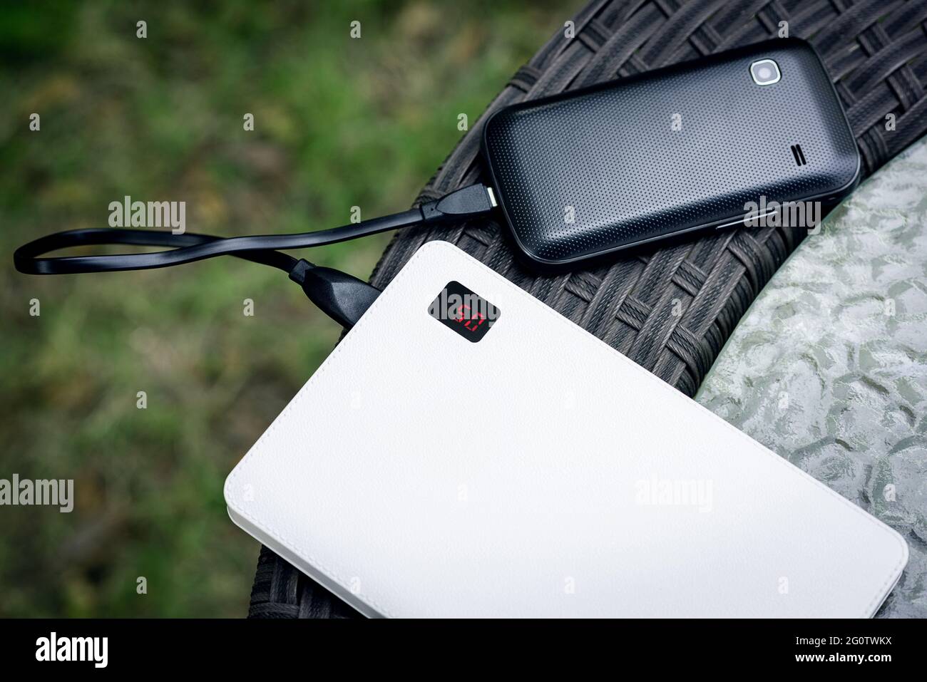 Charging the empty battery smartphone with white power bank Stock Photo ...