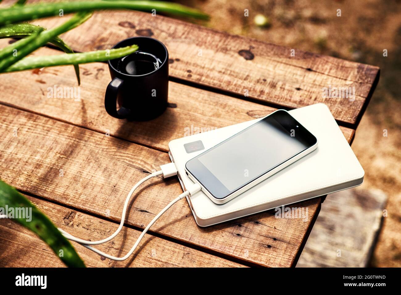 Charging the empty battery smartphone with white power bank Stock Photo ...