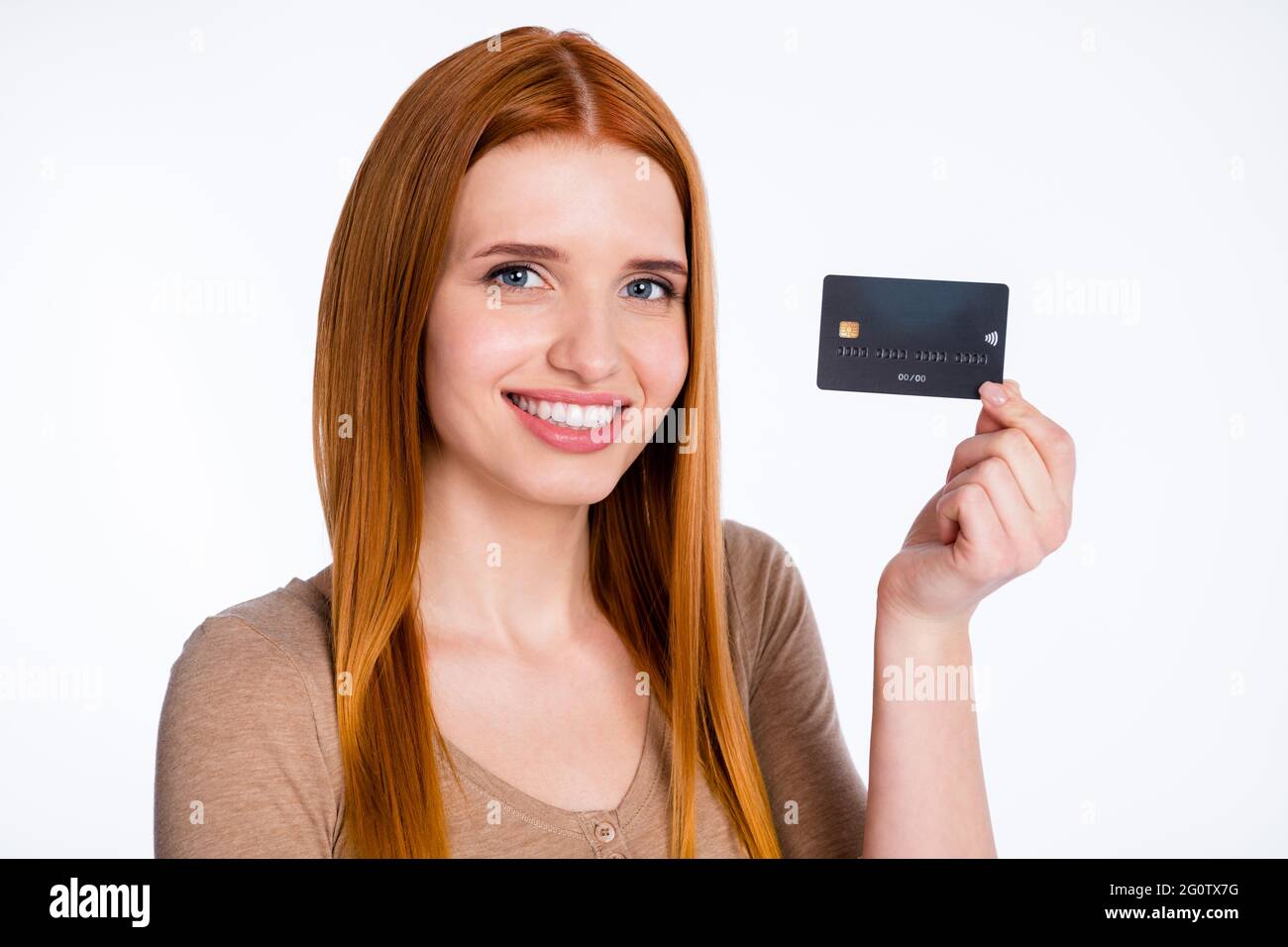Photo of adorable cute ginger lady wear beige shirt smiling holding ...