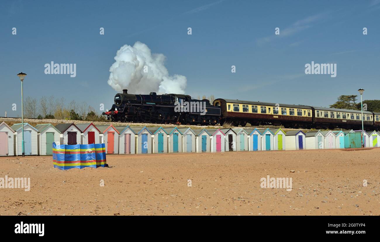 Steam train climbing the gradient past Goodrington beach on the ...