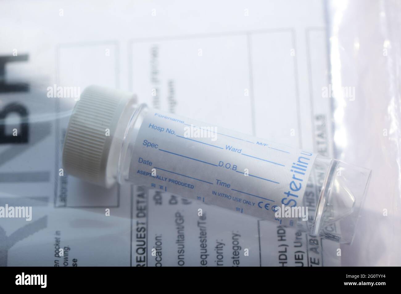 Close-up of a medical sample bottle enclosed in a polythene wrapper ...