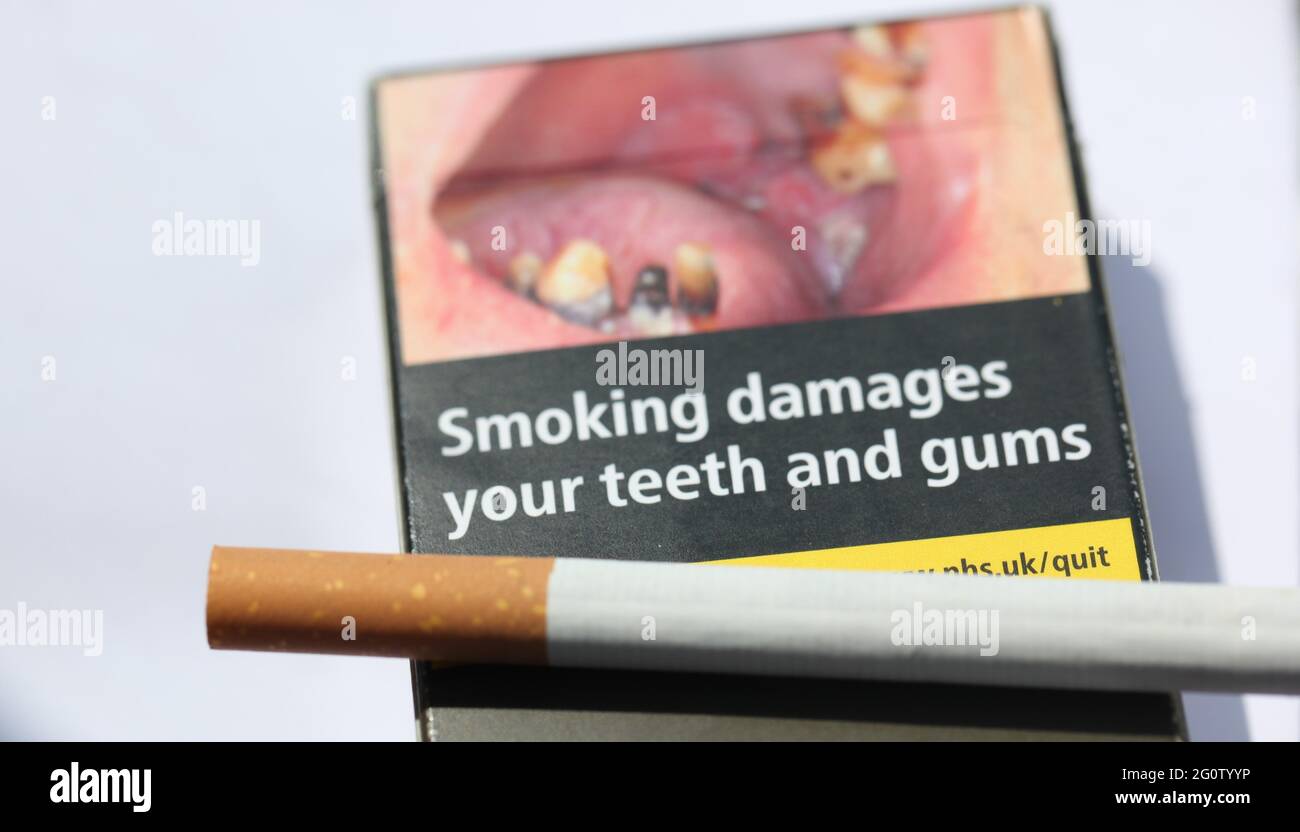 Packet of Open Cigarettes with a single cigarette resting on top of ...