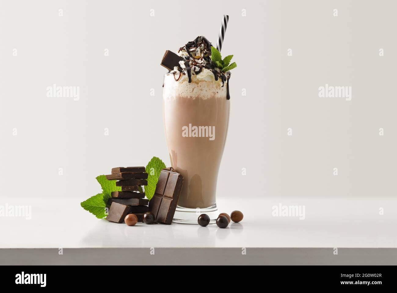 Chocolate milkshake with cream decorated chocolate portions and balls ...