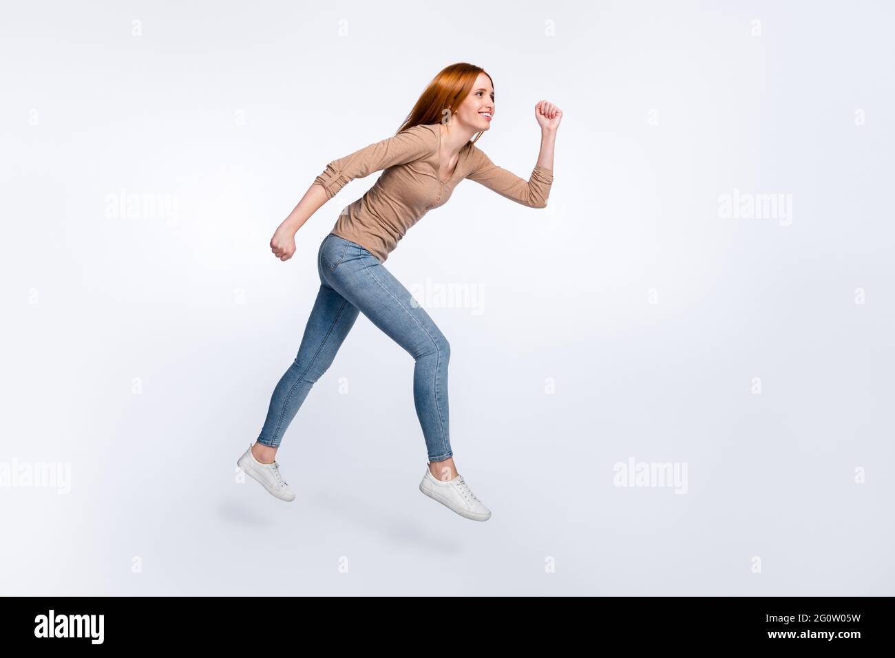 Full length photo of charming hurrying ginger lady wear beige shirt ...