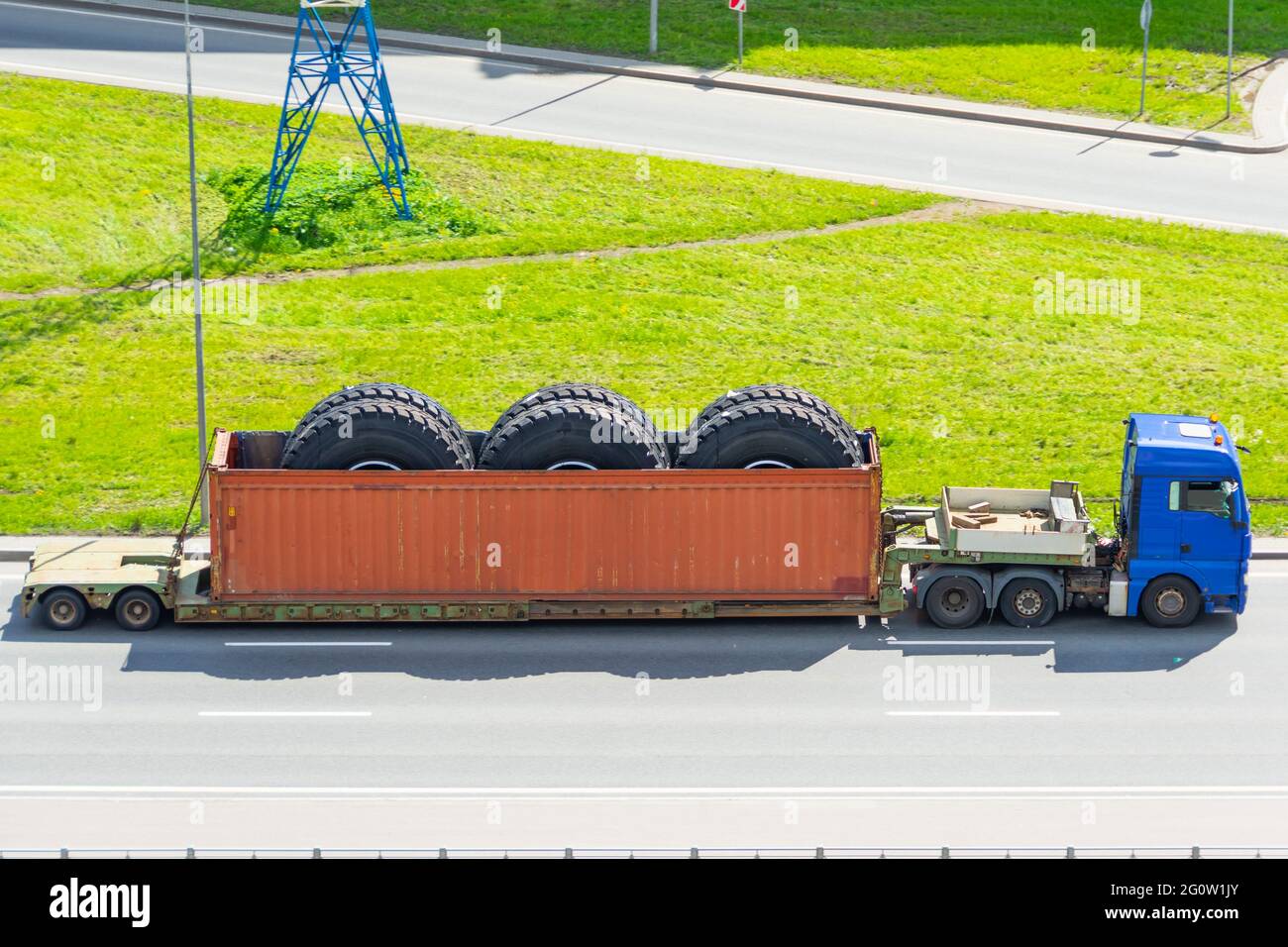 Transporting huge dump truck tire wheels in a container Stock Photo - Alamy