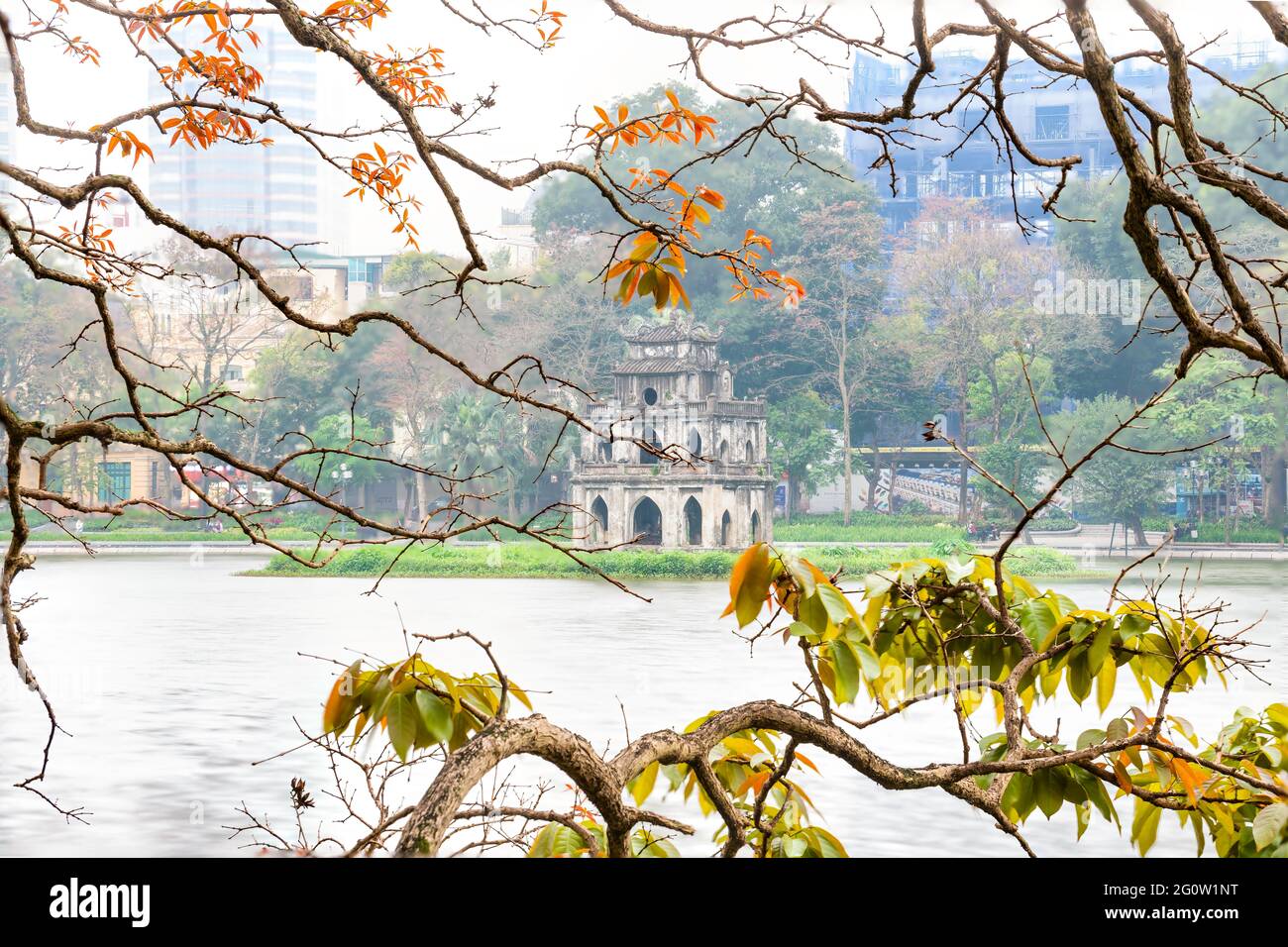 Turtle tower on the Hoan Kiem Lake (Ho Guom) with green trees in Hanoi ...