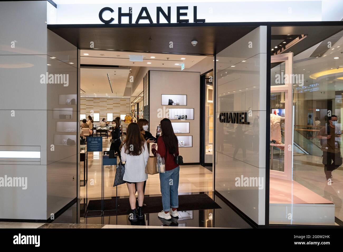 Shoppers have their temperature checked before entering the French ...