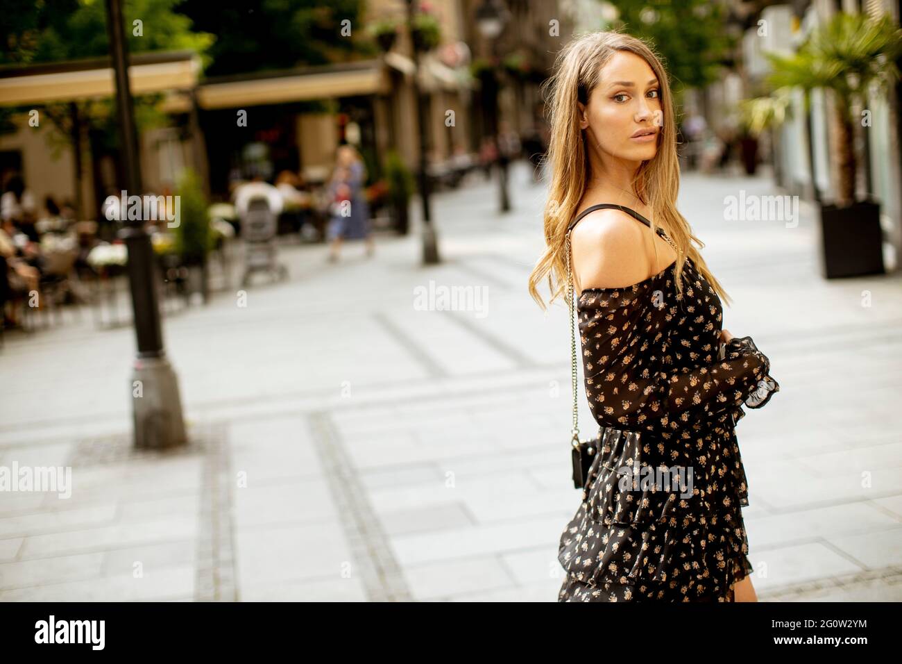Pretty young long hair brunette woman walking on the city street Stock ...