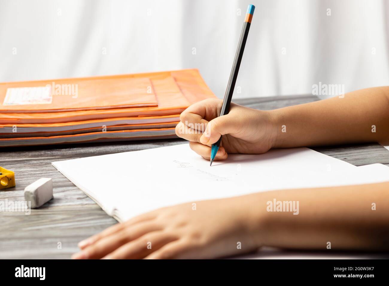 Child writing with pencil hi-res stock photography and images - Alamy