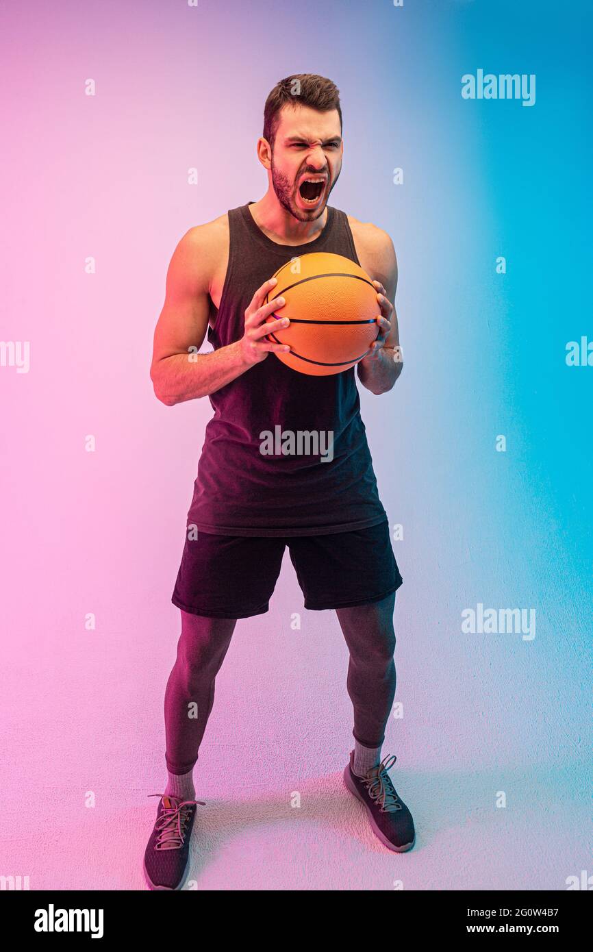 Aggressive european man play basketball in studio Stock Photo - Alamy