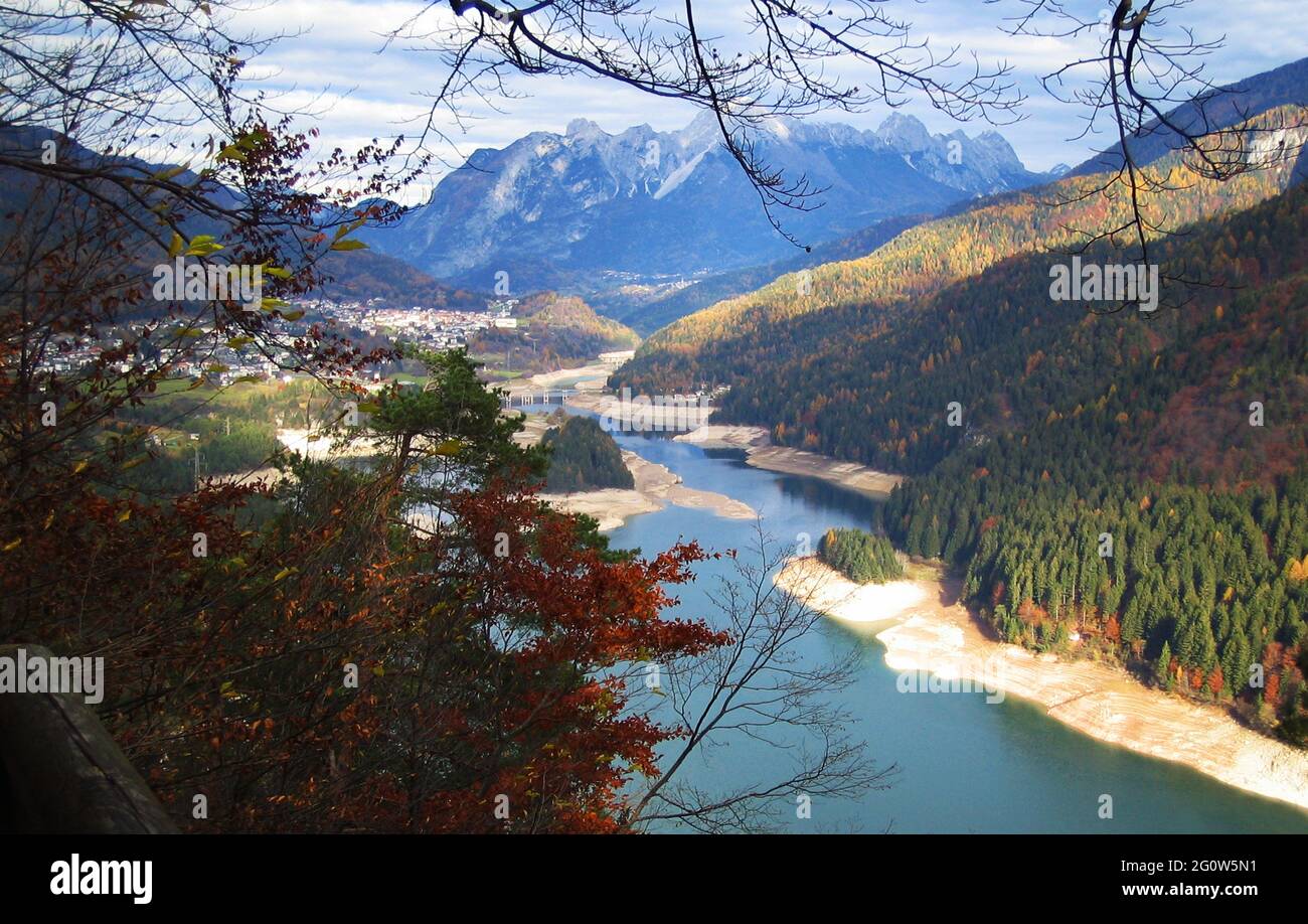 The colors of autumn surround the waters of Lake Cadore Stock Photo - Alamy
