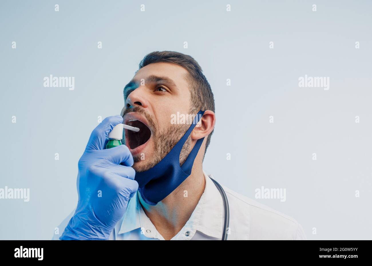 European male doctor use inhaler in studio Stock Photo - Alamy