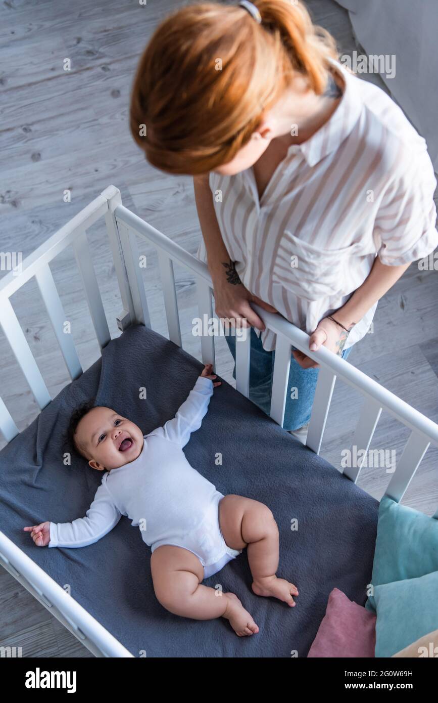 overhead view of woman standing near excited african american daughter ...