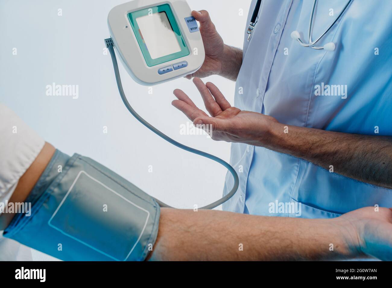 Doctor check pulse of patient with tonometer Stock Photo - Alamy