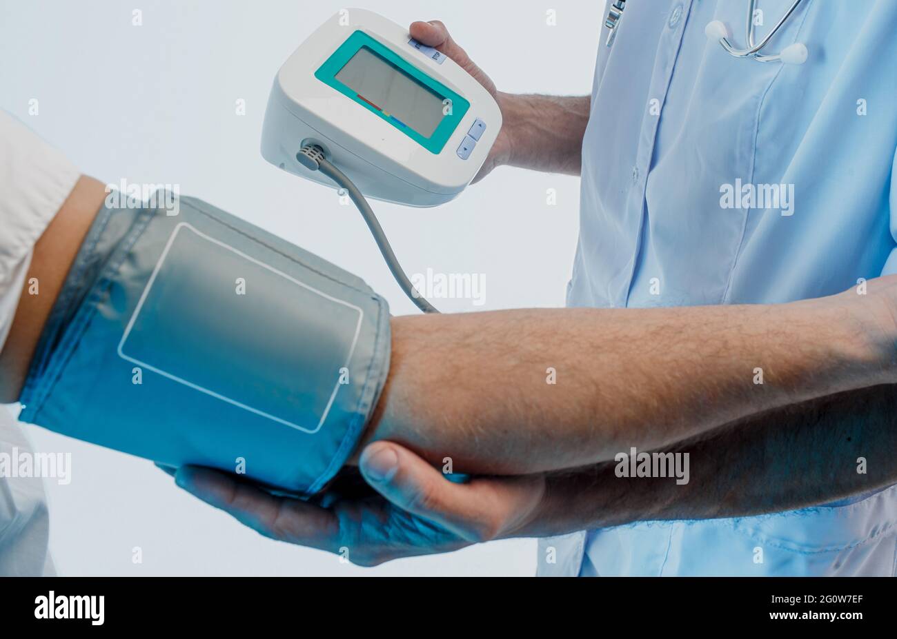Doctor check pulse of patient with tonometer Stock Photo - Alamy