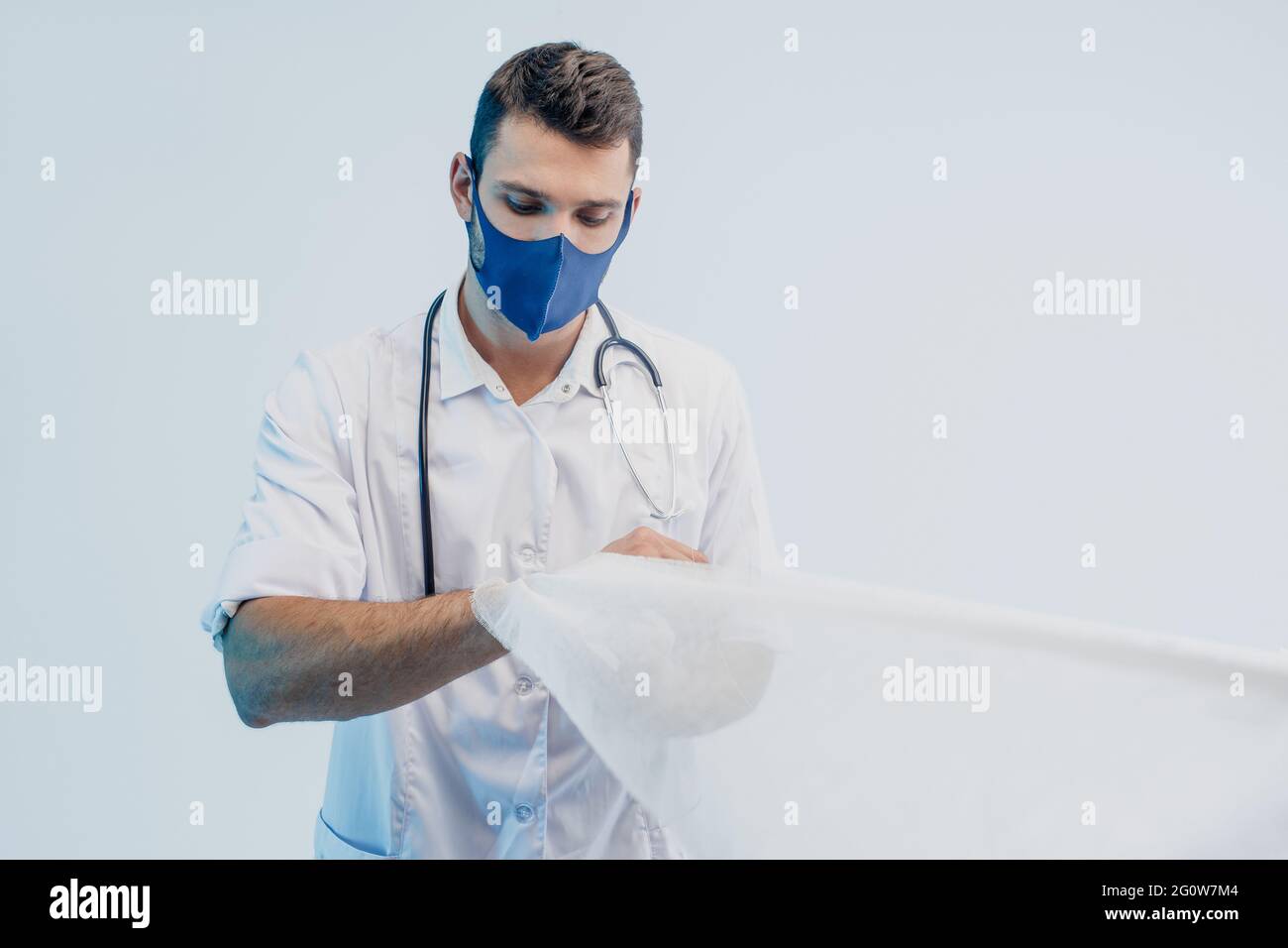 Male doctor wrapping medical bandage on hand Stock Photo - Alamy