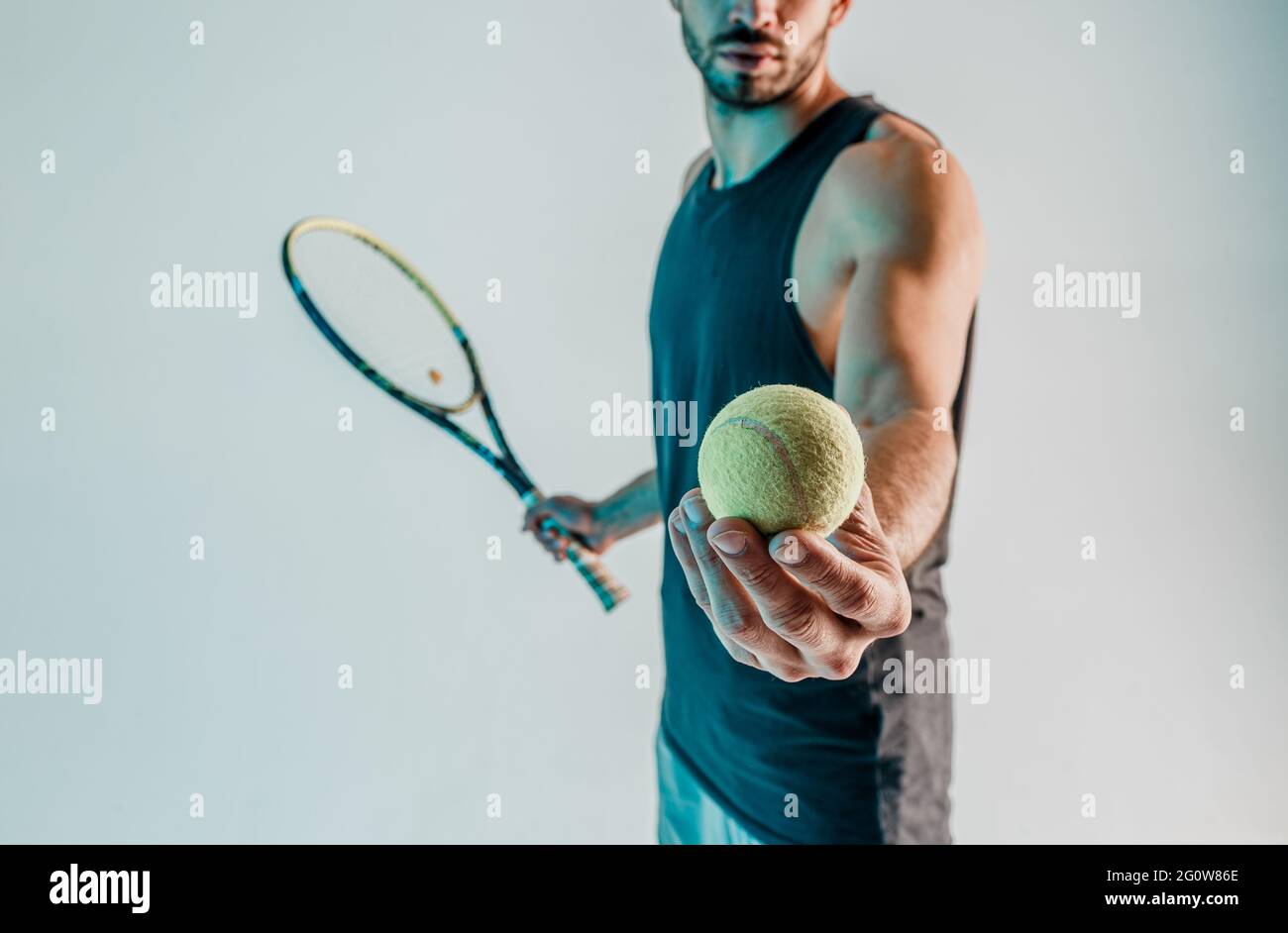 Sportsman hold and showing tennis ball in hand Stock Photo - Alamy