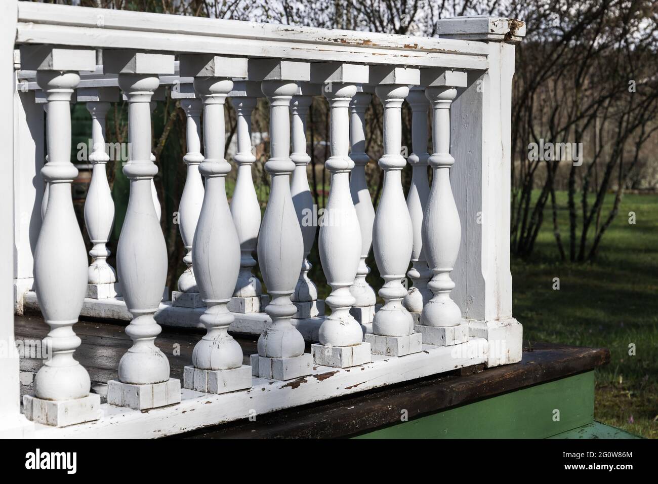 Old terrace railings with balusters made of painted wood. Classical ...