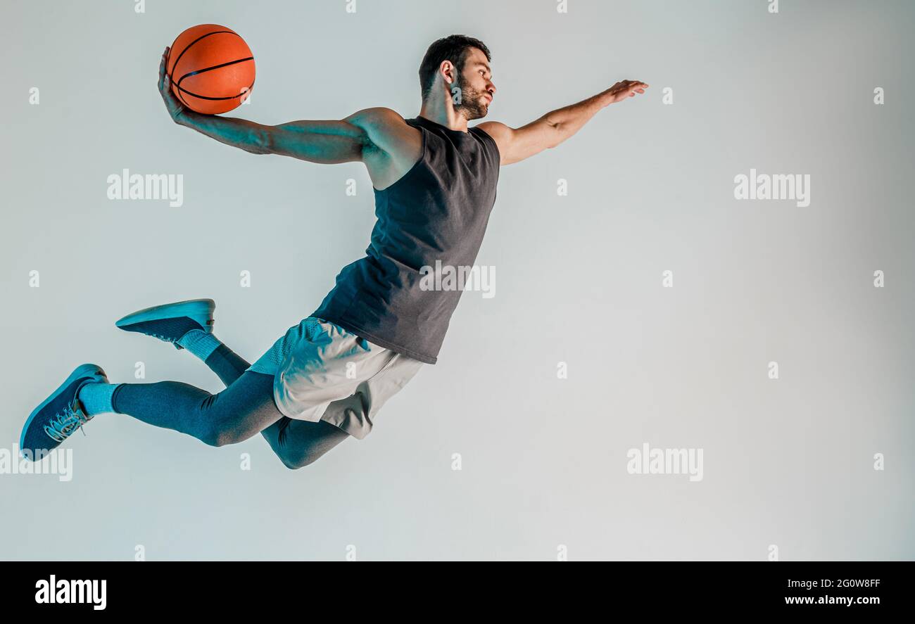 Sportsman jumping and want throw basketball ball Stock Photo - Alamy