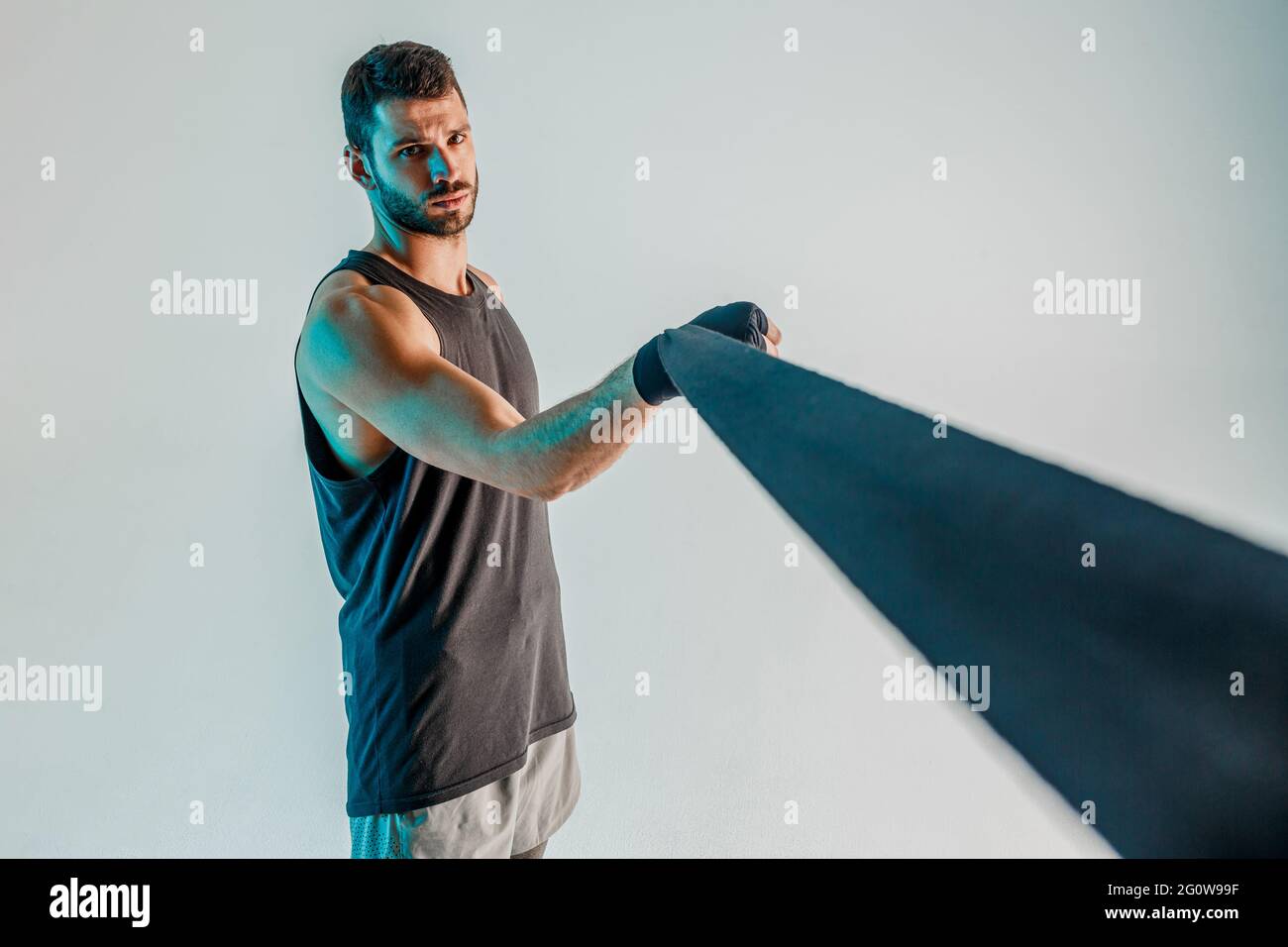 Sportsman wrapping boxing bandage on arm in studio Stock Photo - Alamy
