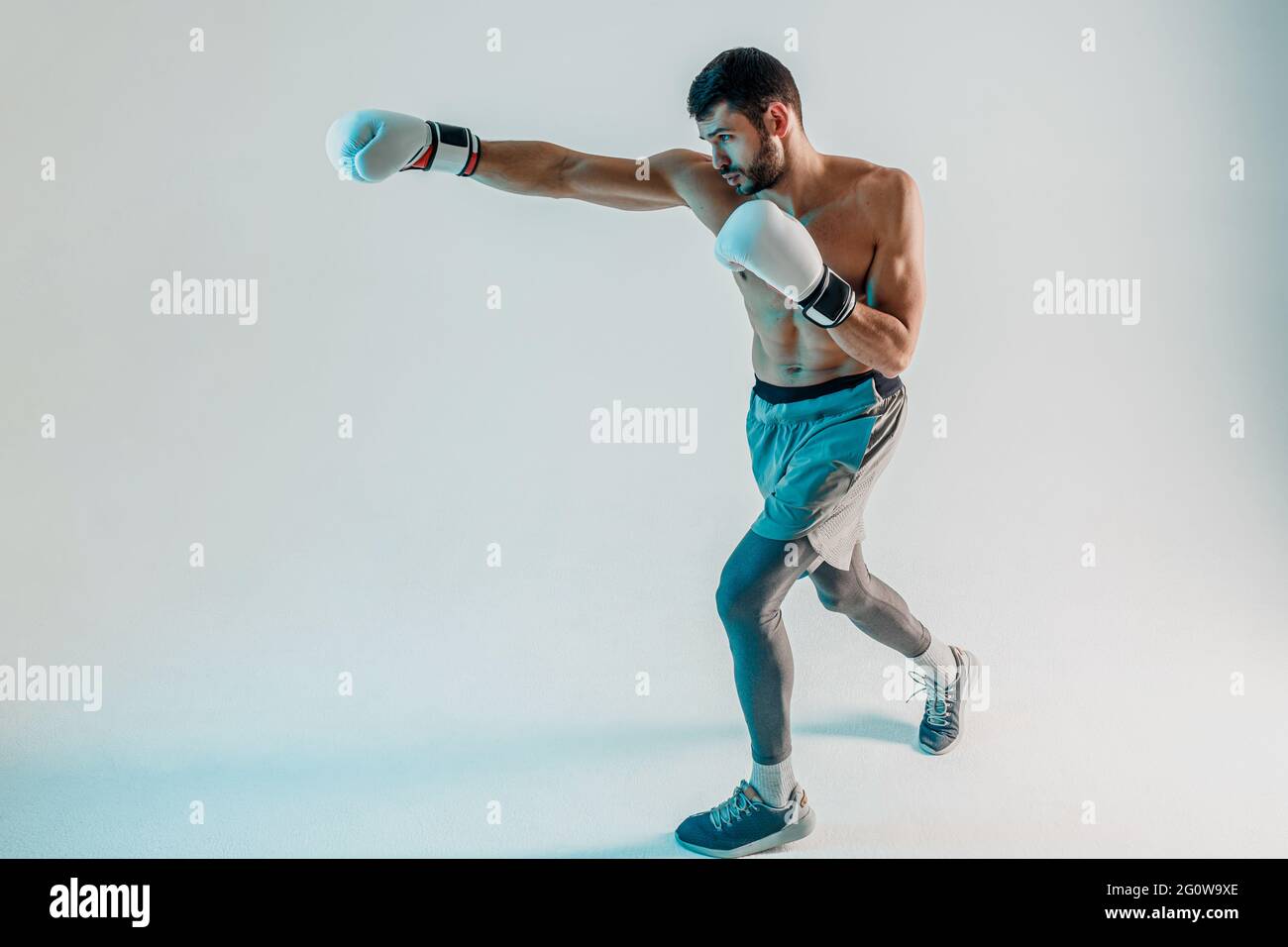 Concentrated european boxer is boxing in studio Stock Photo - Alamy