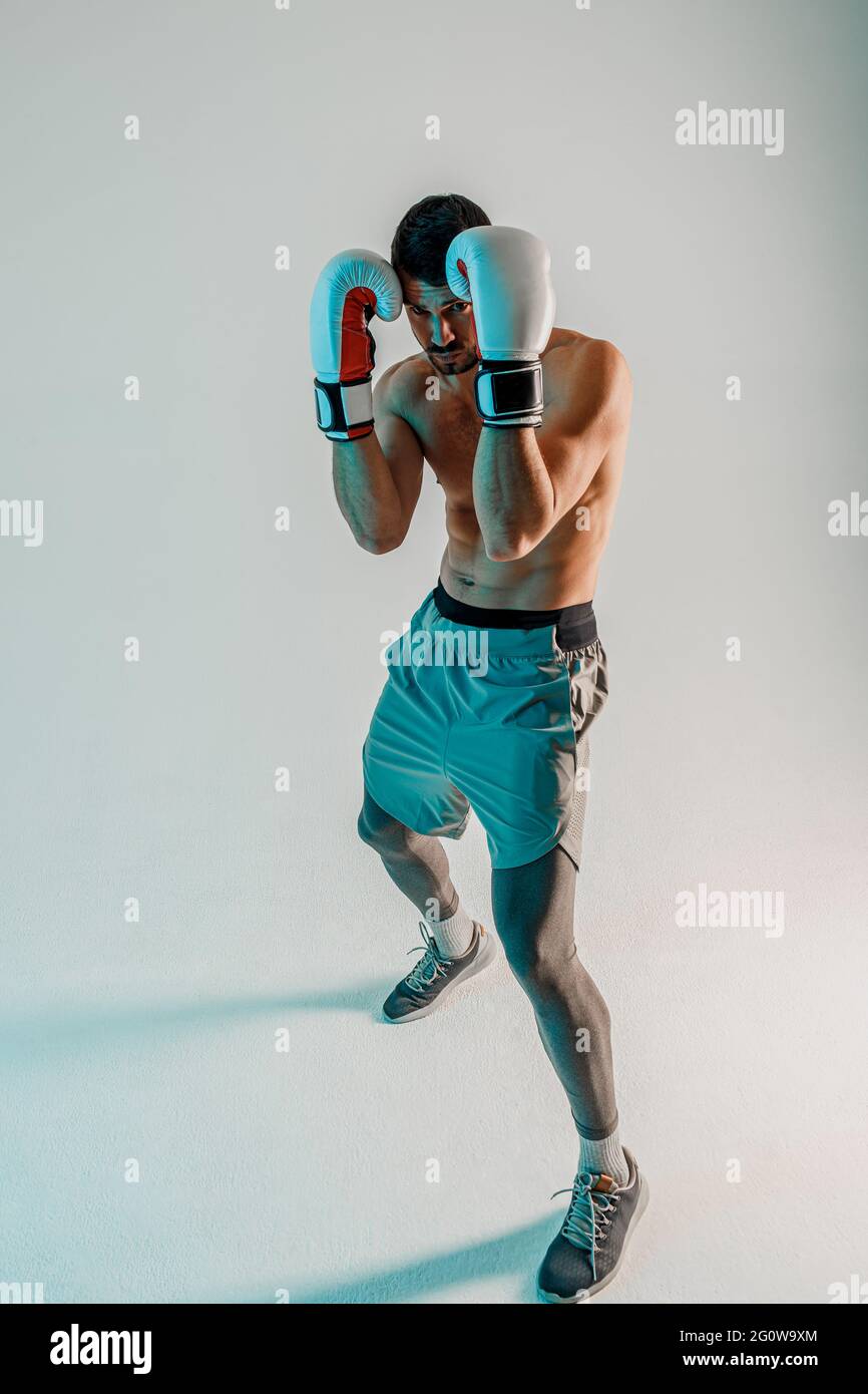 Concentrated european boxer is boxing in studio Stock Photo - Alamy