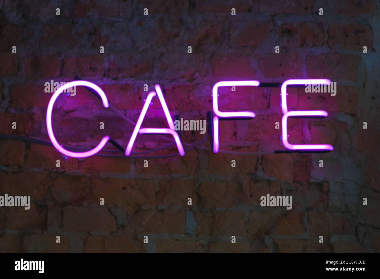 Neon letters, bright signboard cafe on a brick wall close-up Stock ...