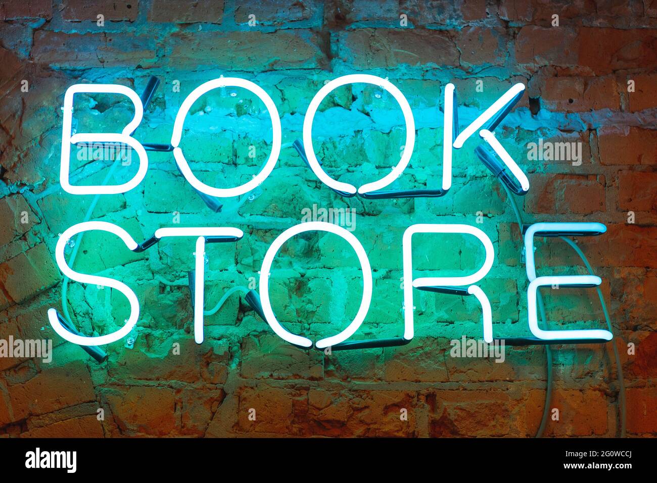 Neon letters, bright signboard bookstore on a brick wall close-up Stock ...