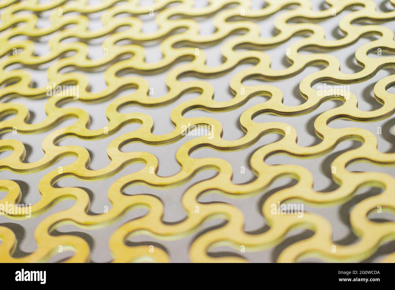 Abstract background, a repeating pattern of gold curved round cells in ...