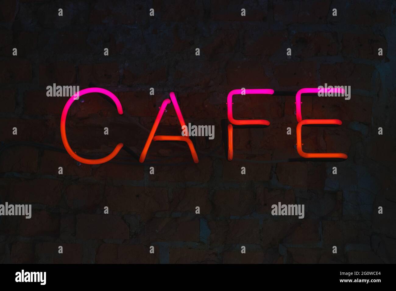 Neon letters, bright signboard cafe on a brick wall close-up Stock ...