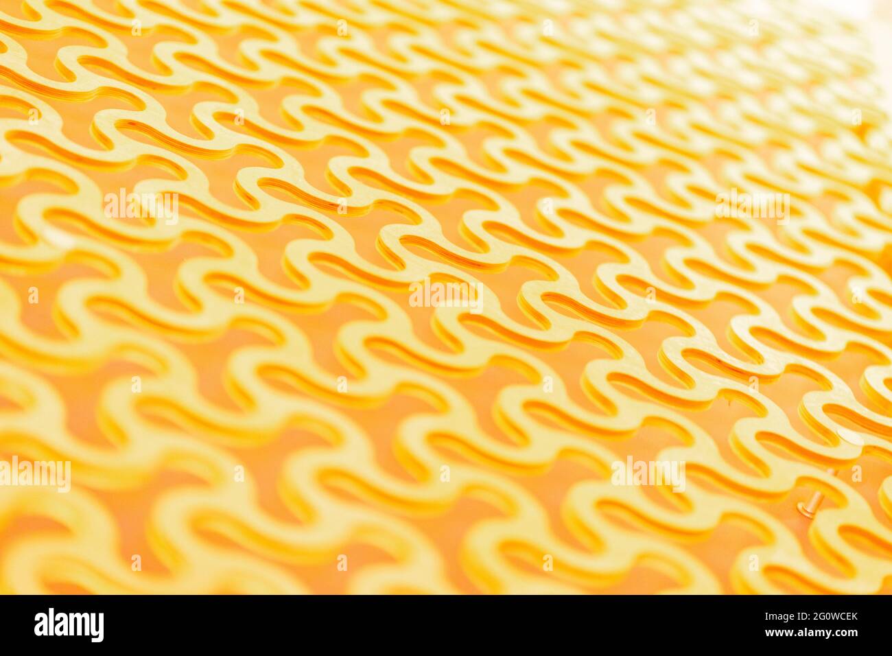 Abstract background, a repeating pattern of gold curved round cells in ...