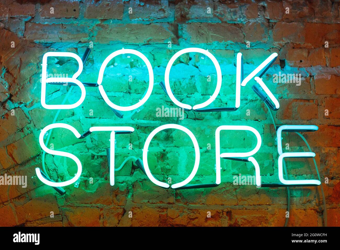 Neon letters, bright signboard bookstore on a brick wall close-up Stock ...