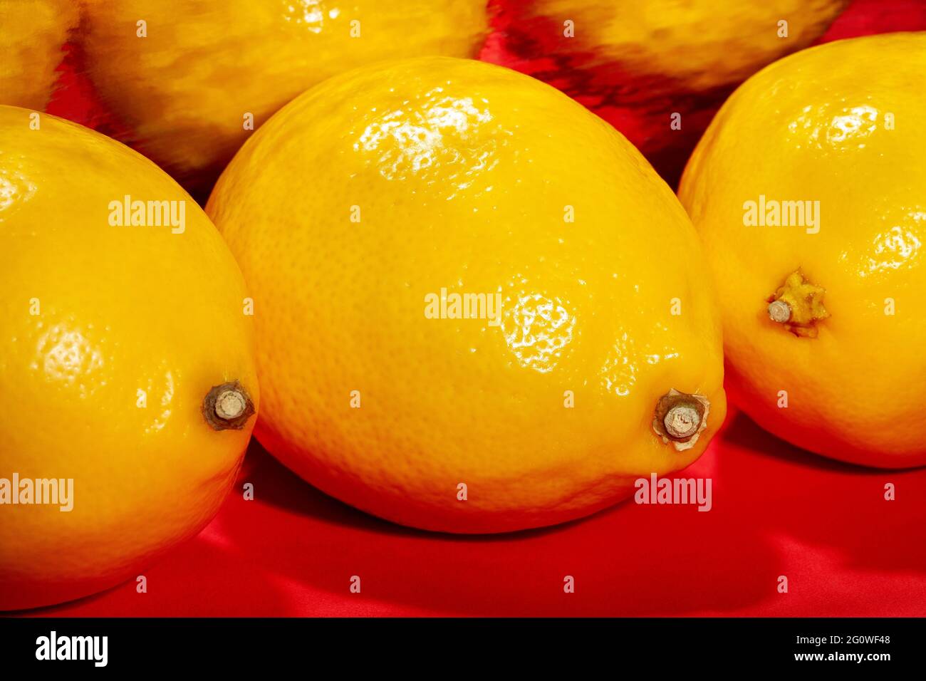 mirrored lemon on red background Stock Photo - Alamy