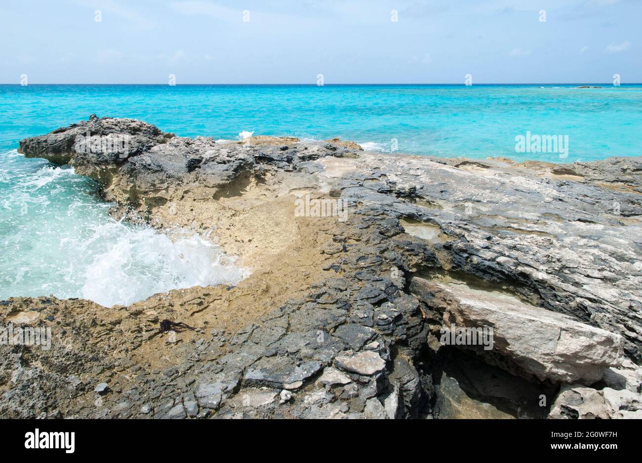 The wave hitting rocky eroded shore on Half Moon Cay island (Bahamas ...