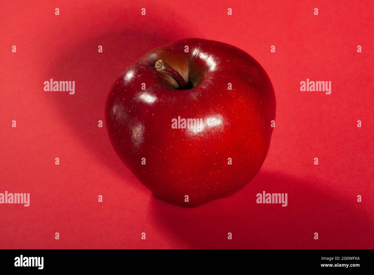 red delicious apple on red background Stock Photo - Alamy