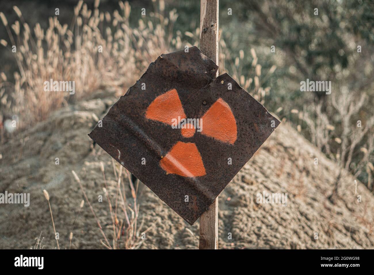 Radiation sign on a rusty metal plate. Hazard warning. Post-apocalyptic ...