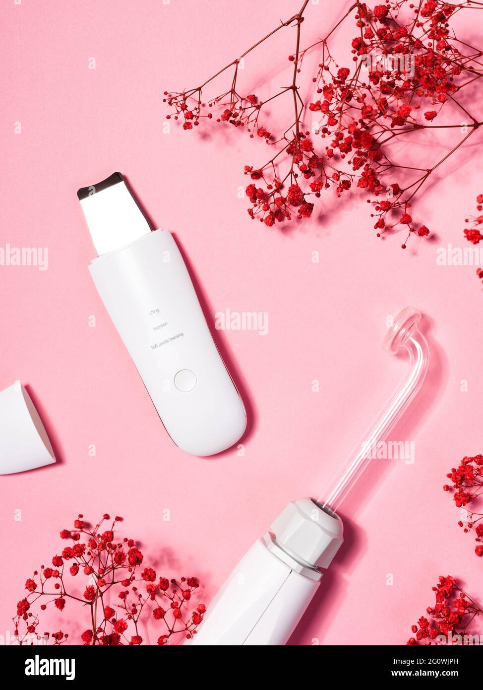 Ultrasonic water peeling and high-frequency beauty home devices on pink ...