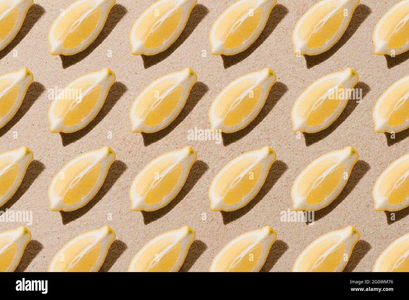 Minimal nature pattern with lemon slices. Sand background. Summer fruit ...