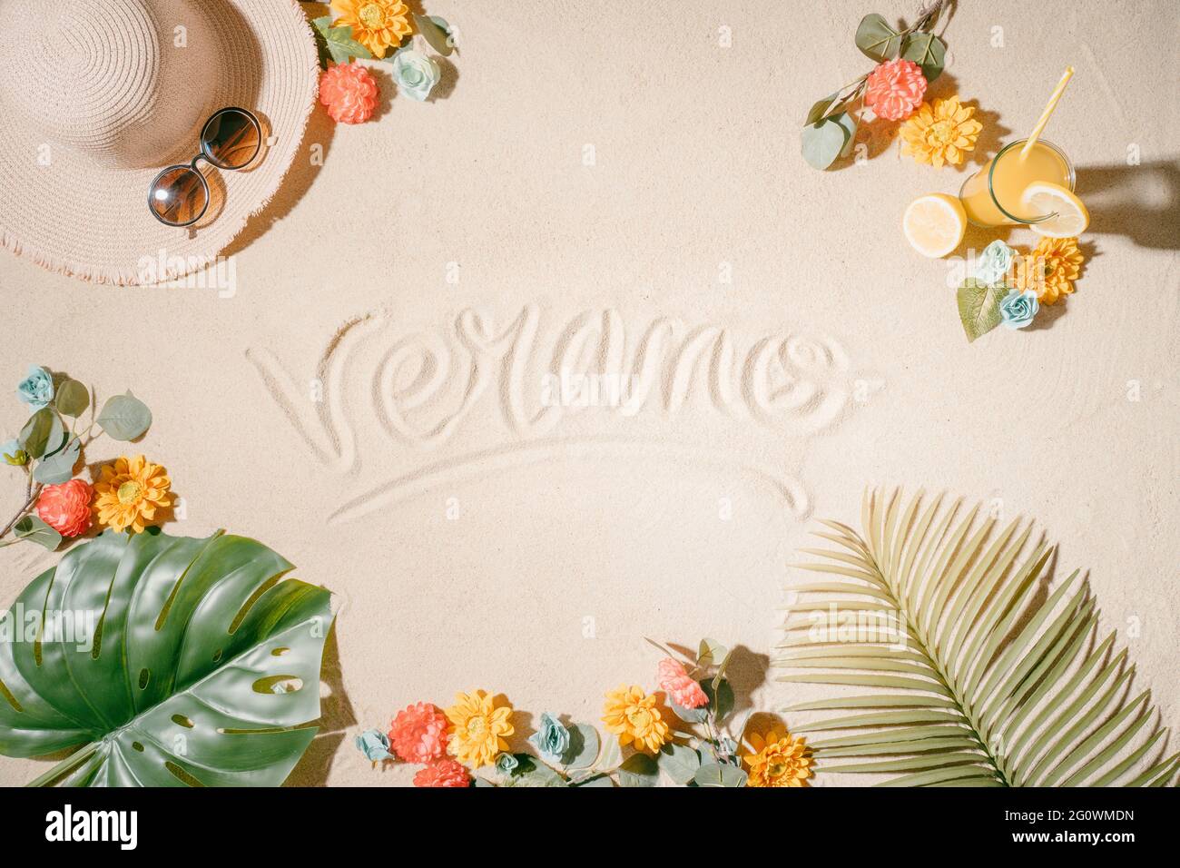 the word summer in spanish written on a sandy beach background with a ...