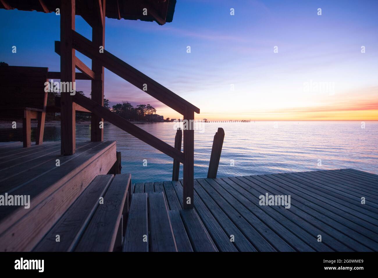 The sky at sunset is framed by a municipal pier in Fairhope, Alabama ...