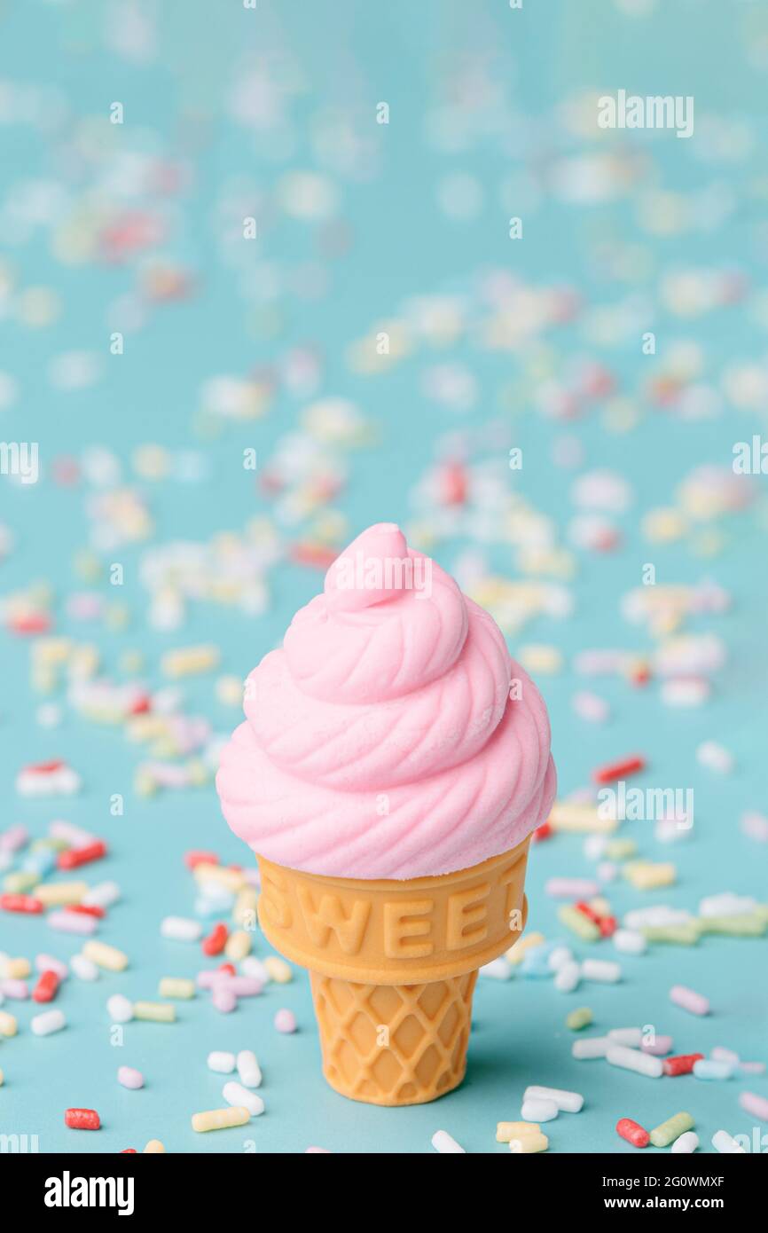 ice cream on blue background with colourful candy sprinkles. Concept of ...