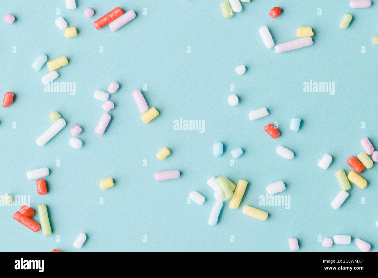 Blue background with colourful candy sprinkle. Concept of summer and ...