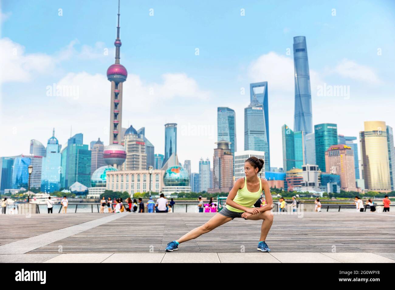 Running runner woman stretching legs in urban city Stock Photo - Alamy